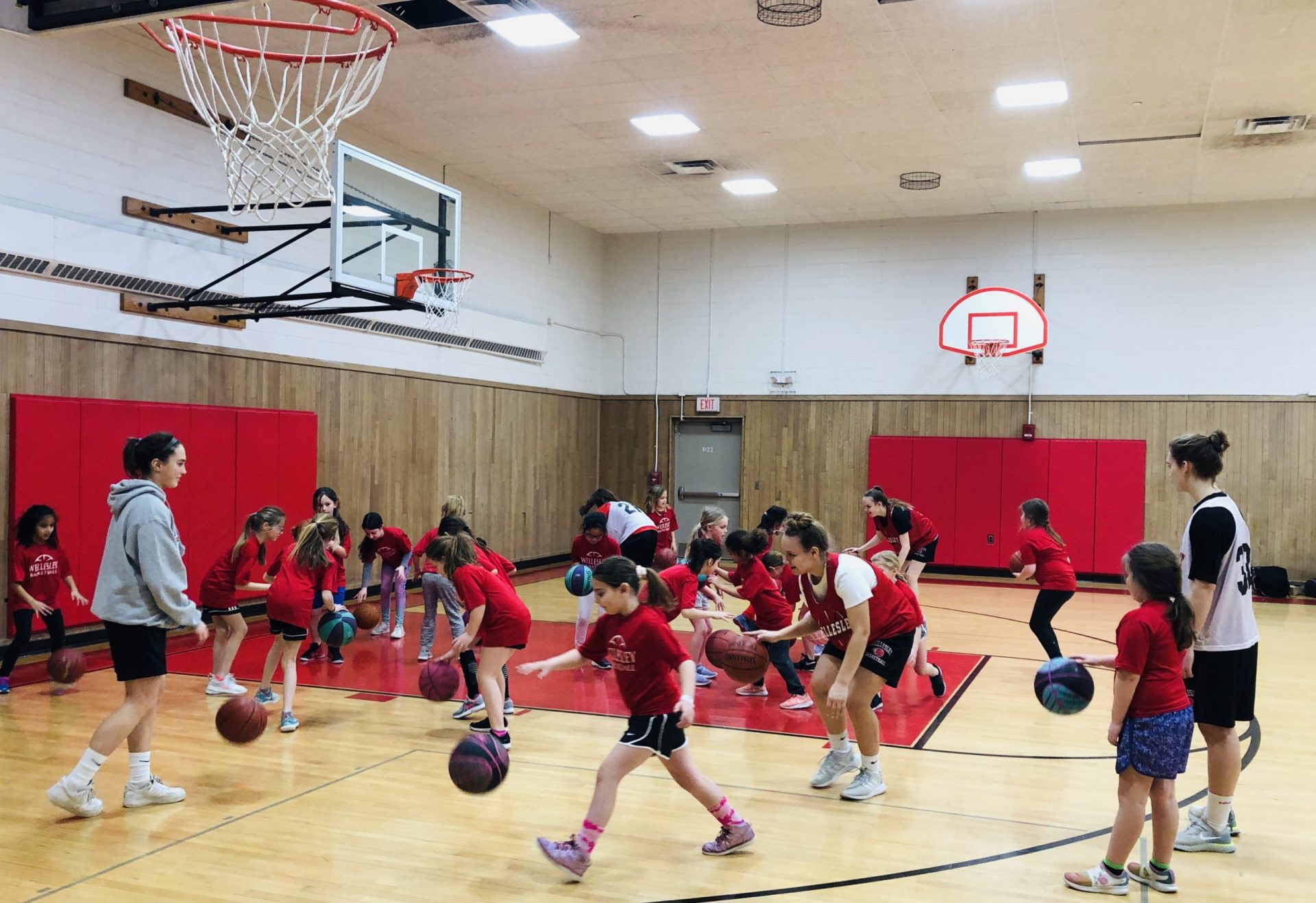 Wellesley High basketball players passing it forward to youngsters ...